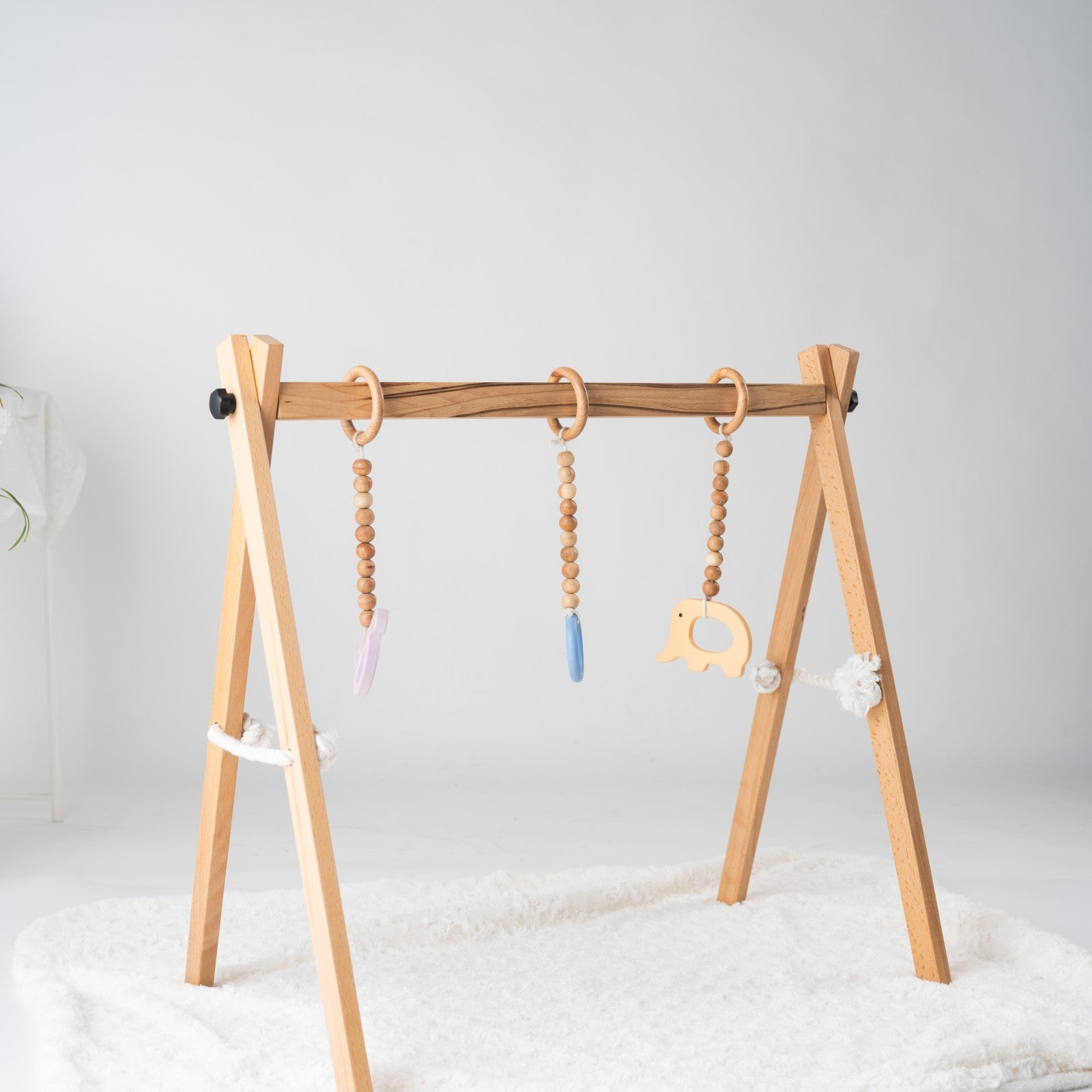 Baby play gym with teathers and felt toys